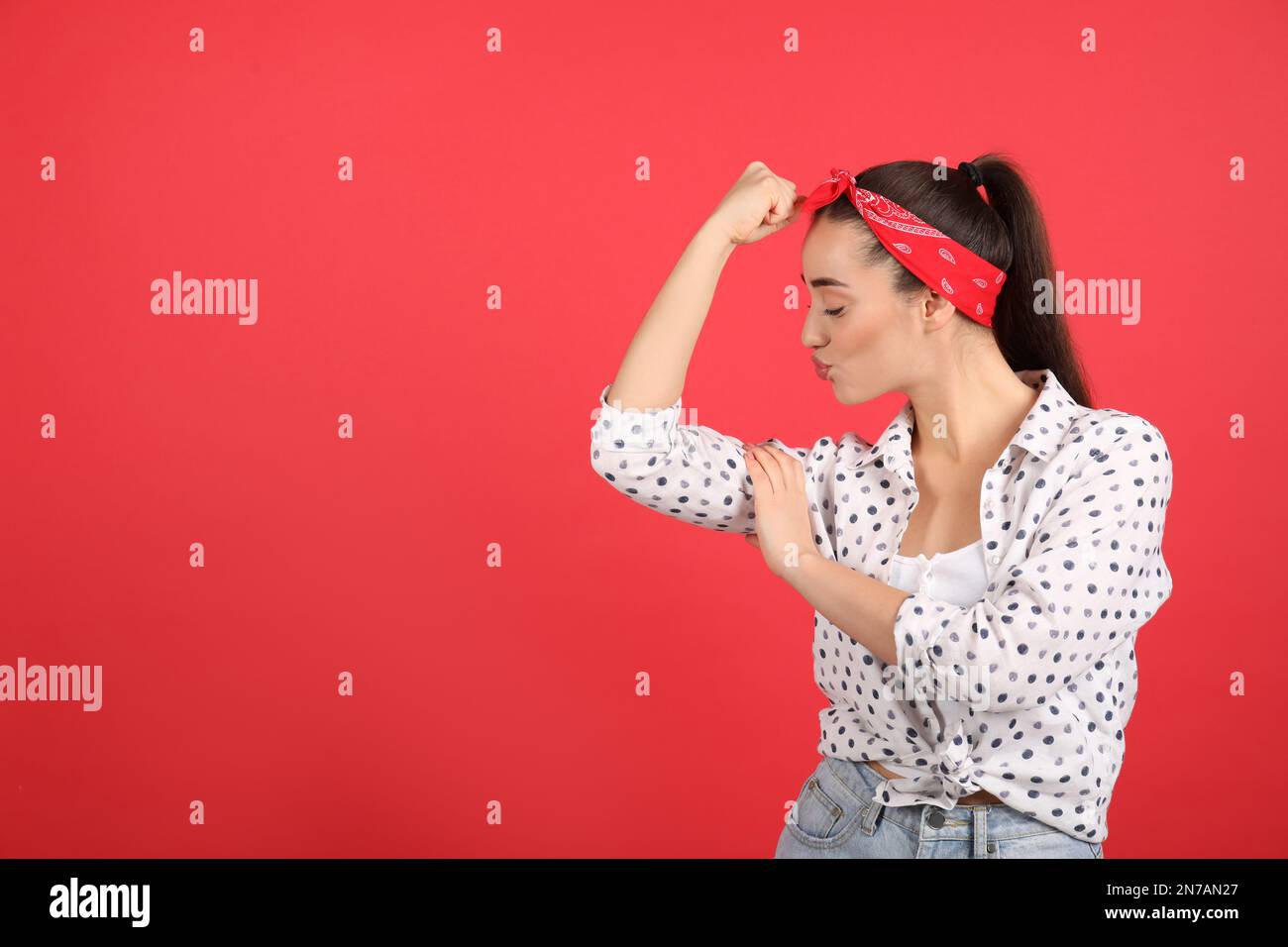 Strong woman as symbol of girl power on red background, space for text ...