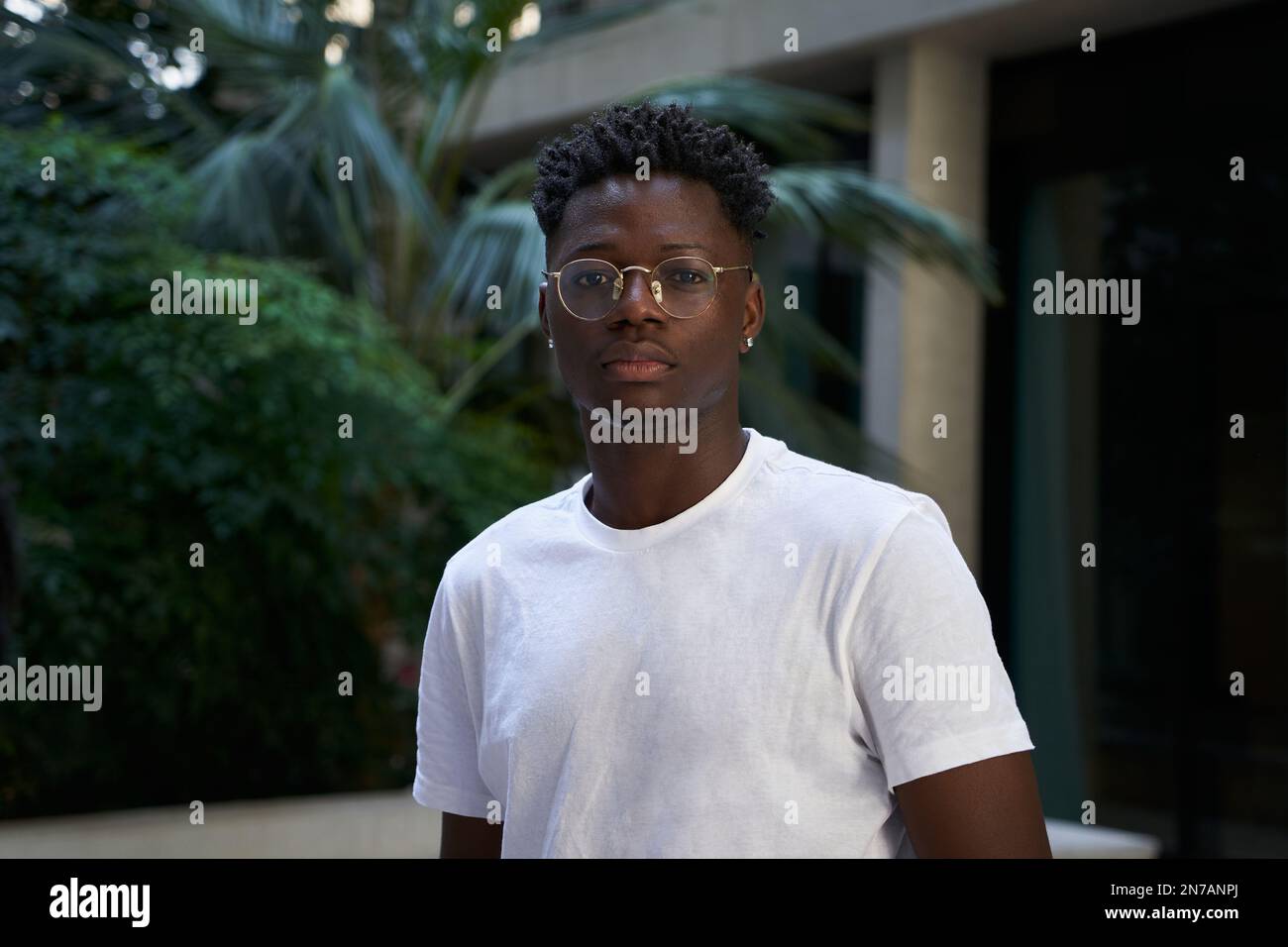 Portrait of serious black man, concentrating and looking at camera ...