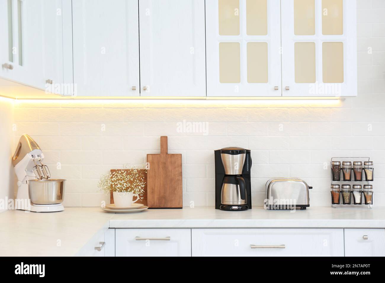 Modern toaster and household appliances on counter in kitchen Stock ...