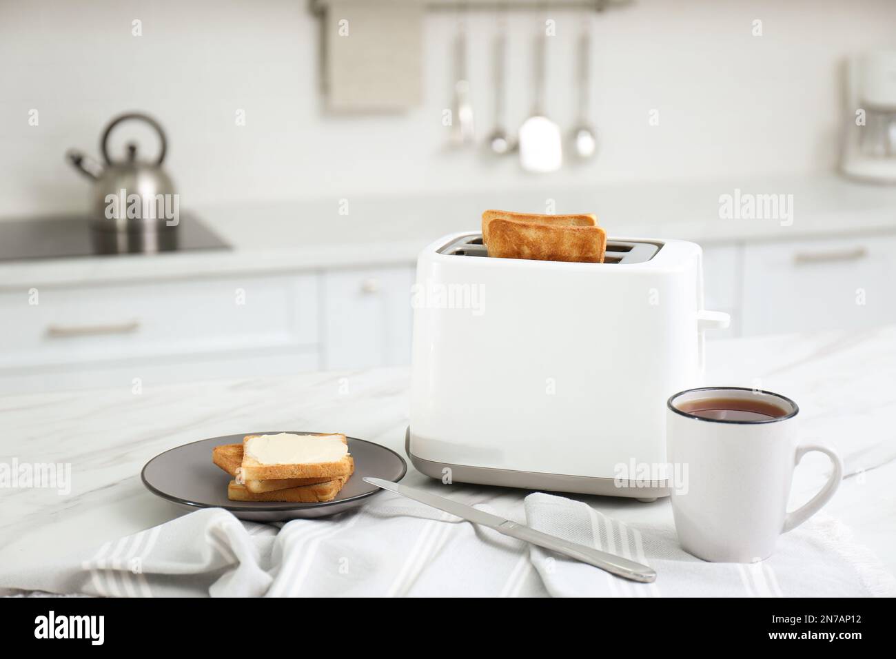 Modern toaster and tasty breakfast on white marble table in kitchen Stock Photo - Alamy