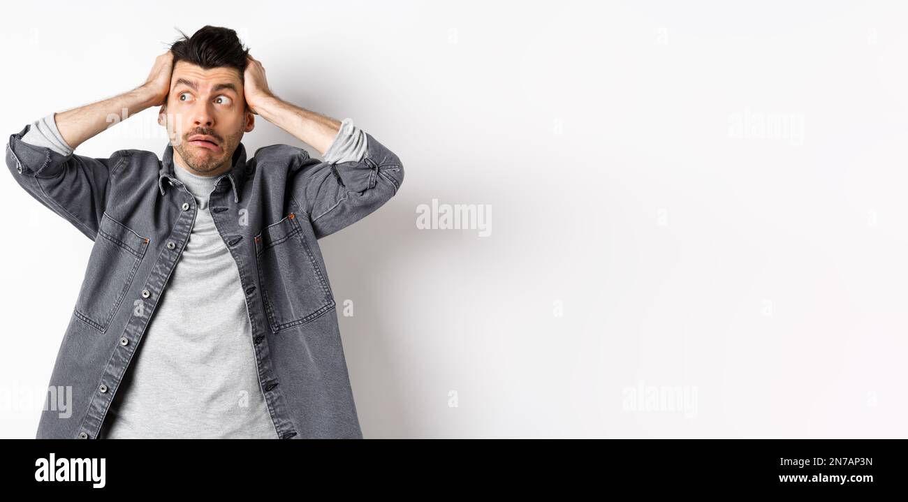 Guy looking aside in panic, stare at logo nervous and alarmed, having ...