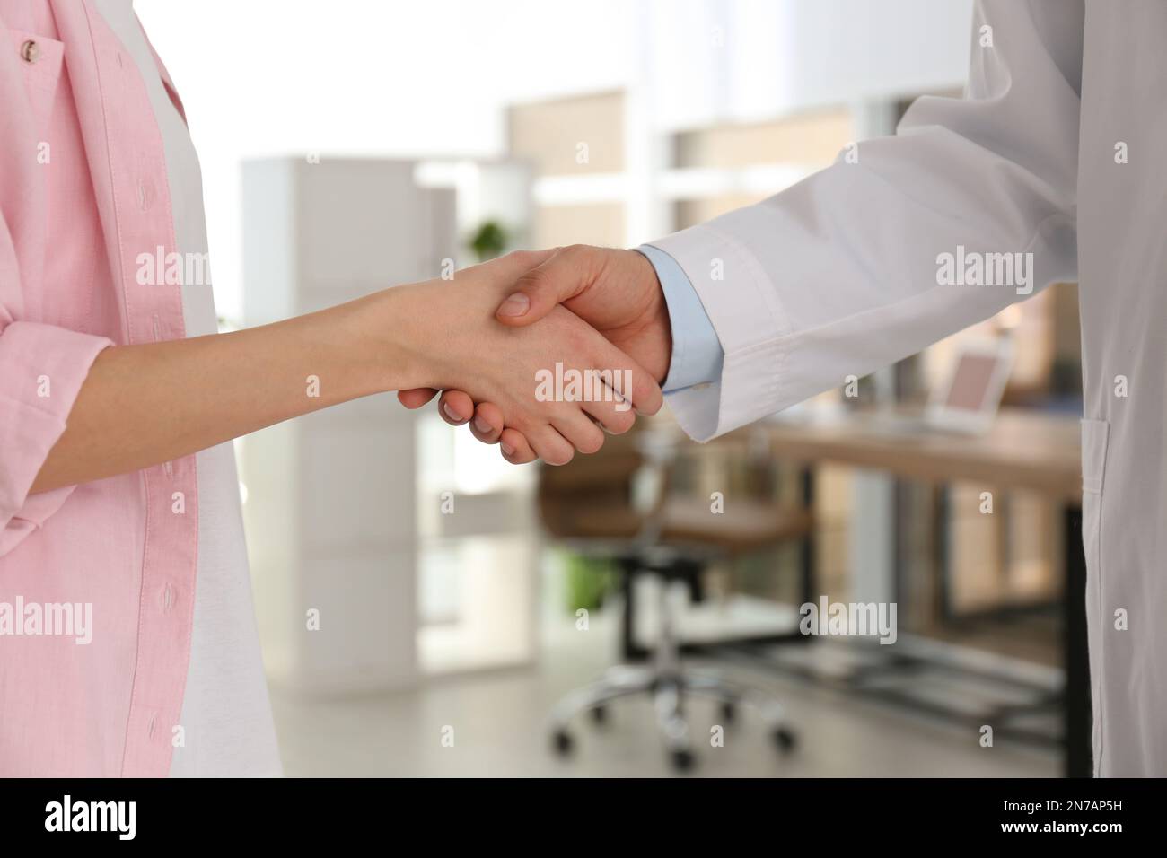Doctor and patient shaking hands in clinic, closeup Stock Photo - Alamy