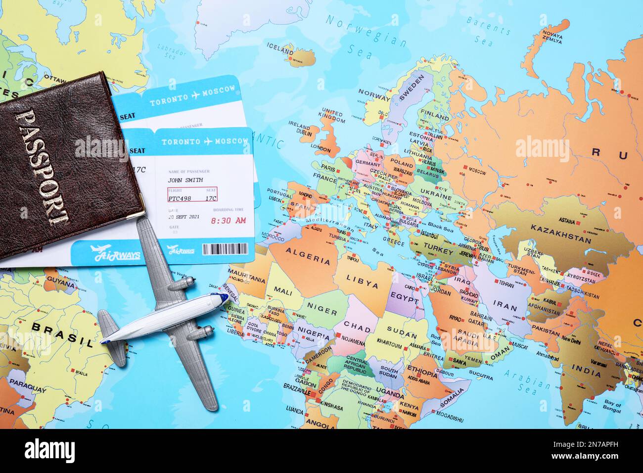 Toy airplane and passport with tickets on world map, flat lay. Space ...