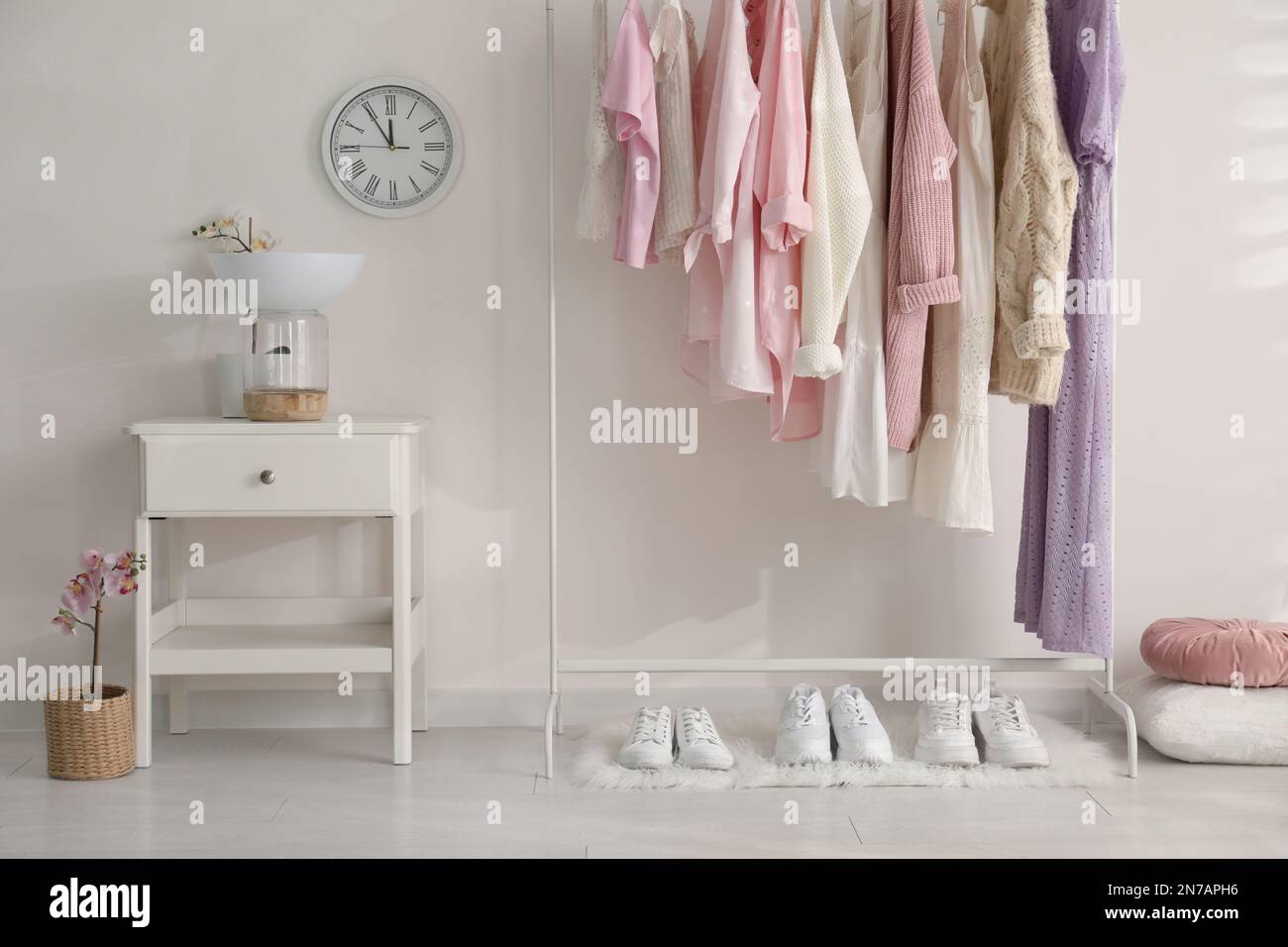 Dressing room interior with clothing rack and nightstand Stock Photo ...
