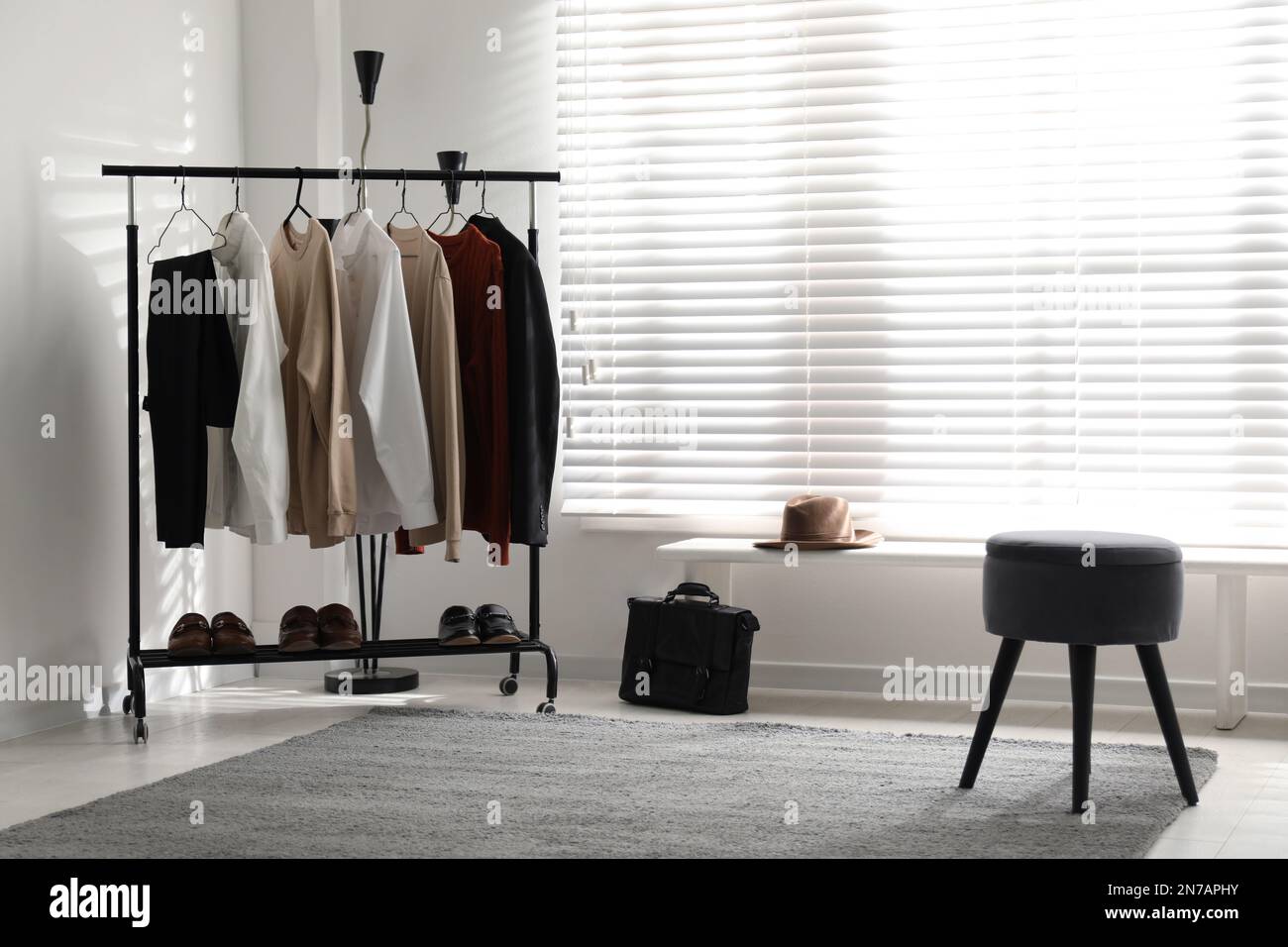 Rack with stylish men's clothes indoors. Interior design Stock Photo ...