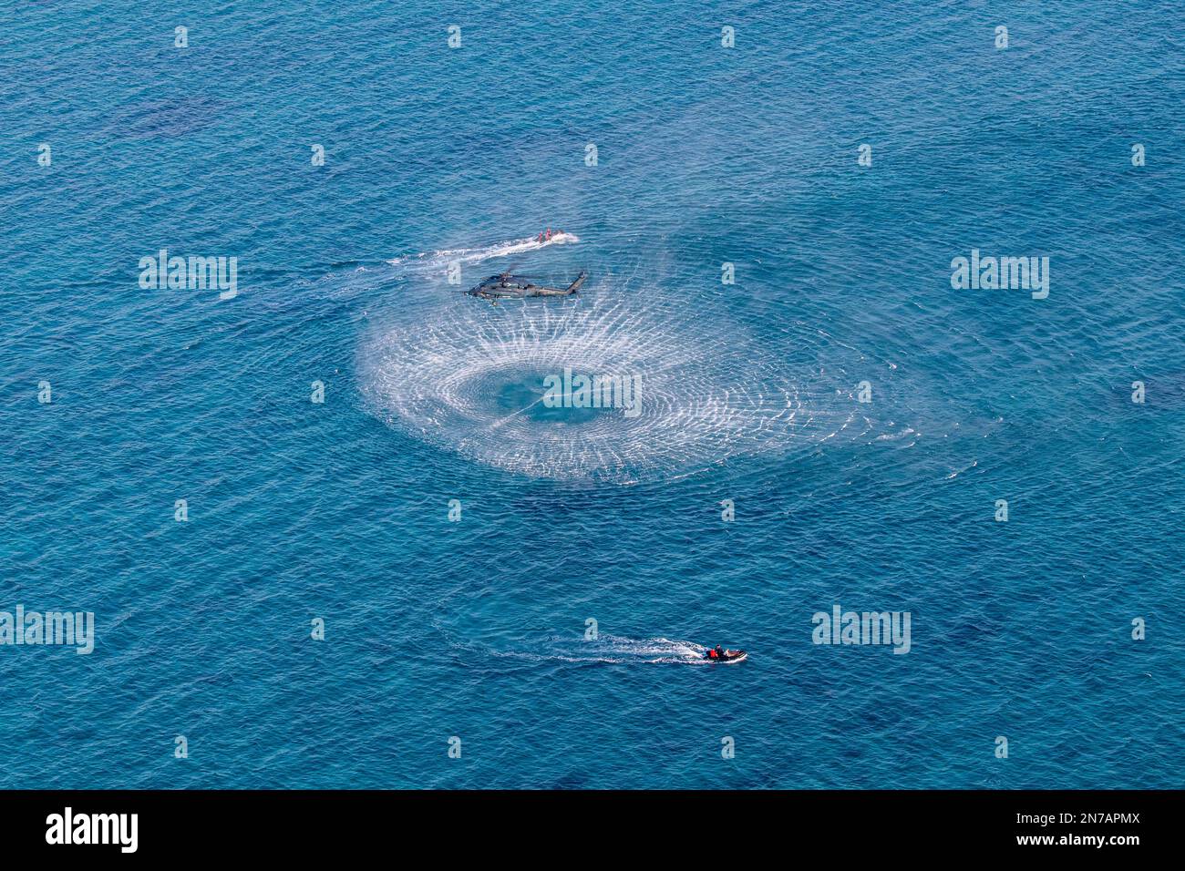 A Japanese Air Self-Defense Force UH-60J helicopter hovers while two U ...