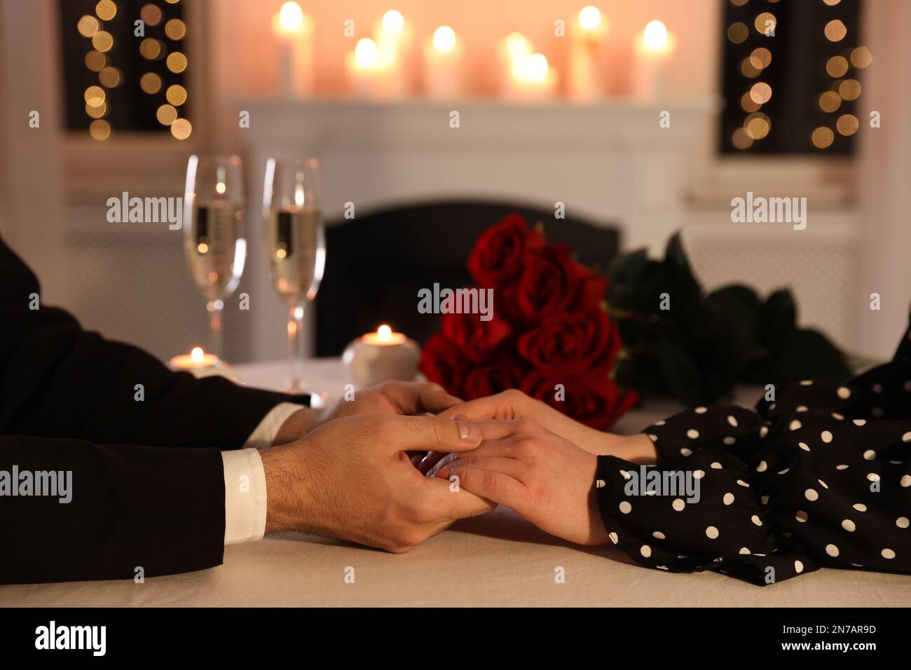 Couple holding hands dinner table hi-res stock photography and images ...
