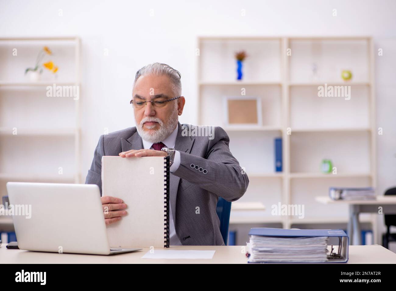 Old employee working in the office Stock Photo - Alamy