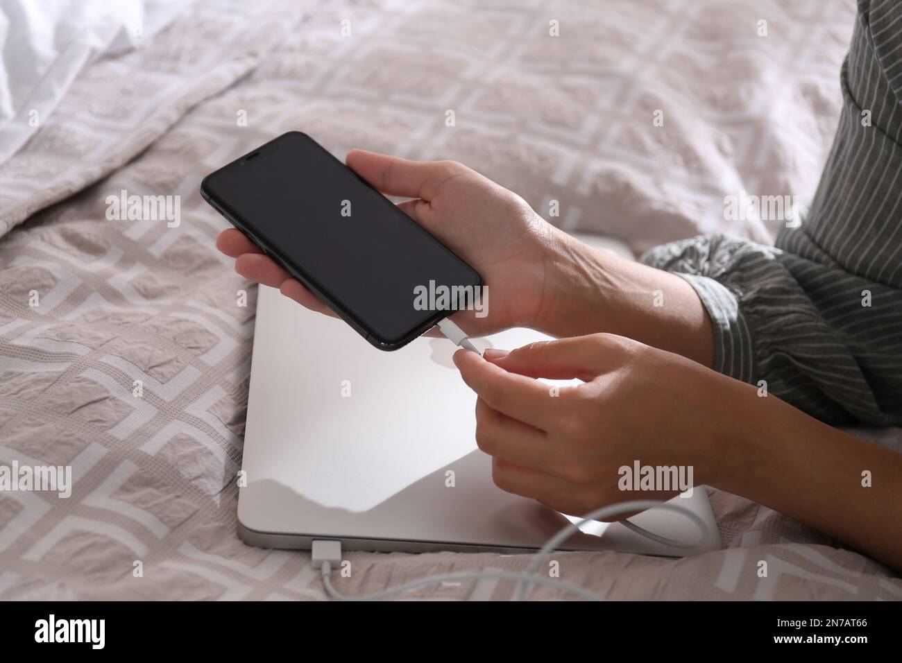 Woman connecting charging cable hi-res stock photography and images - Alamy