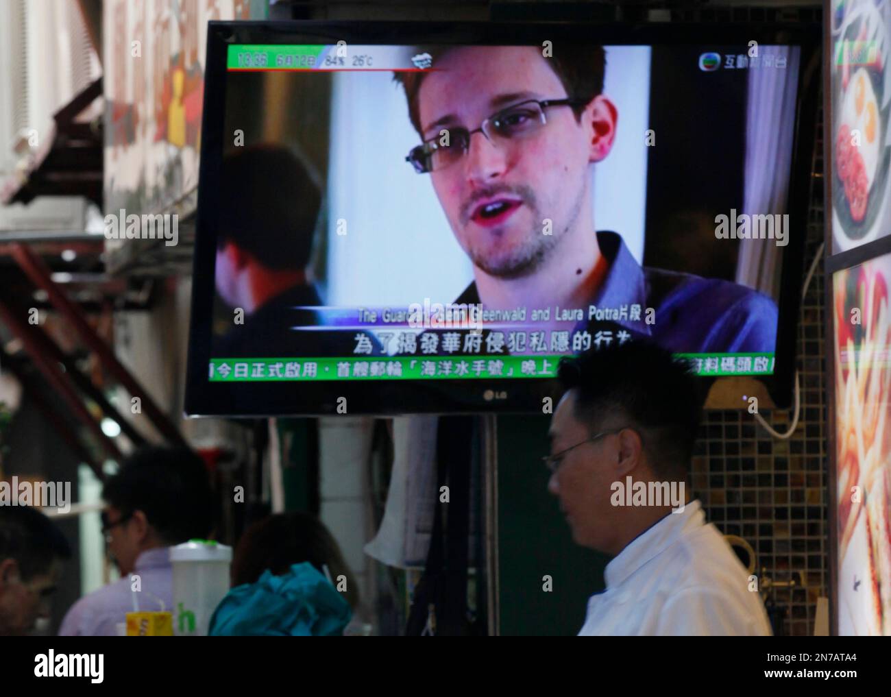 A TV screen shows the news of Edward Snowden, former CIA employee who ...