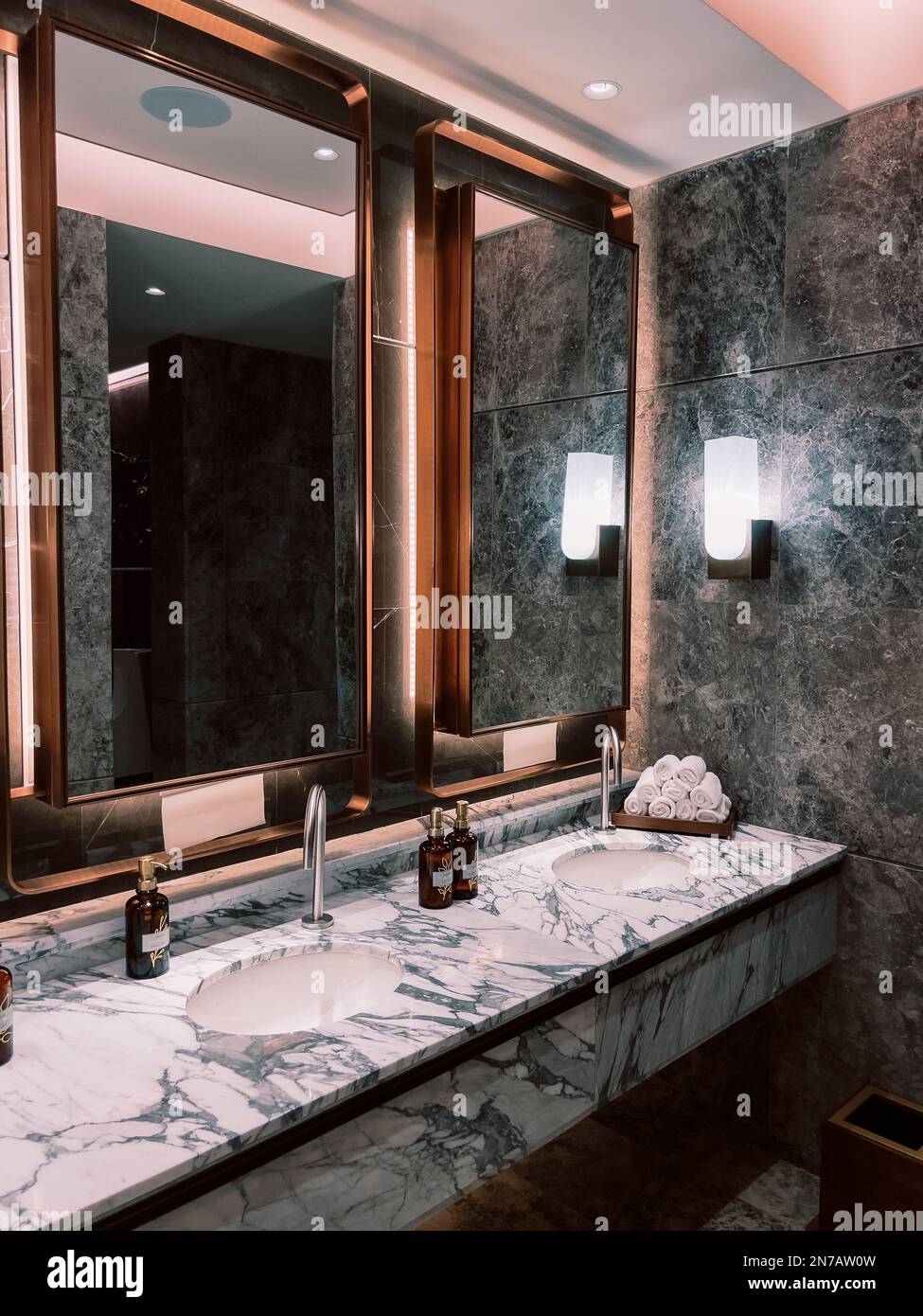 Marble wash basins with mirrors in a hotel bathroom Stock Photo - Alamy
