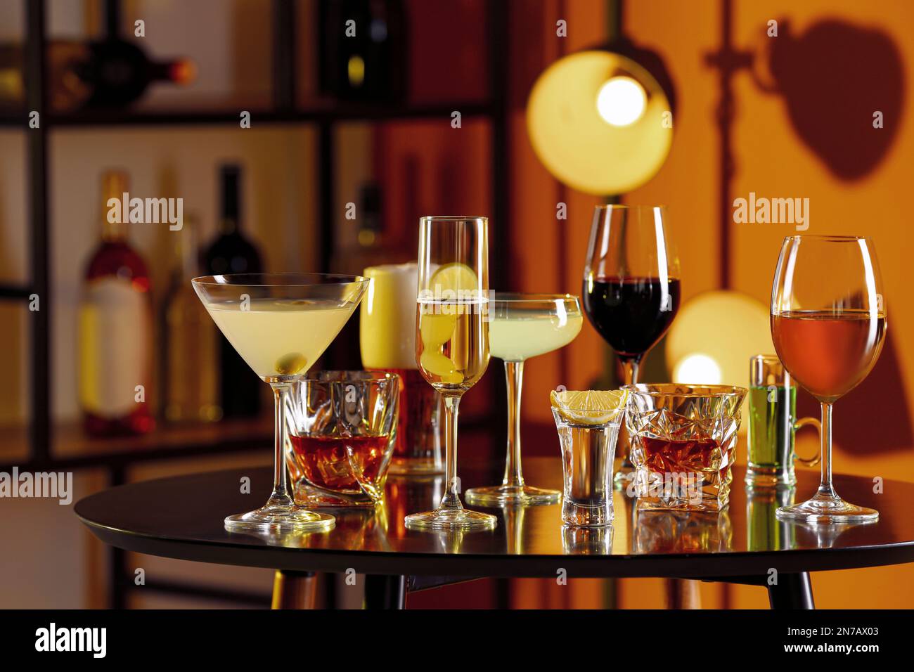 Different alcohol drinks on table in bar Stock Photo - Alamy