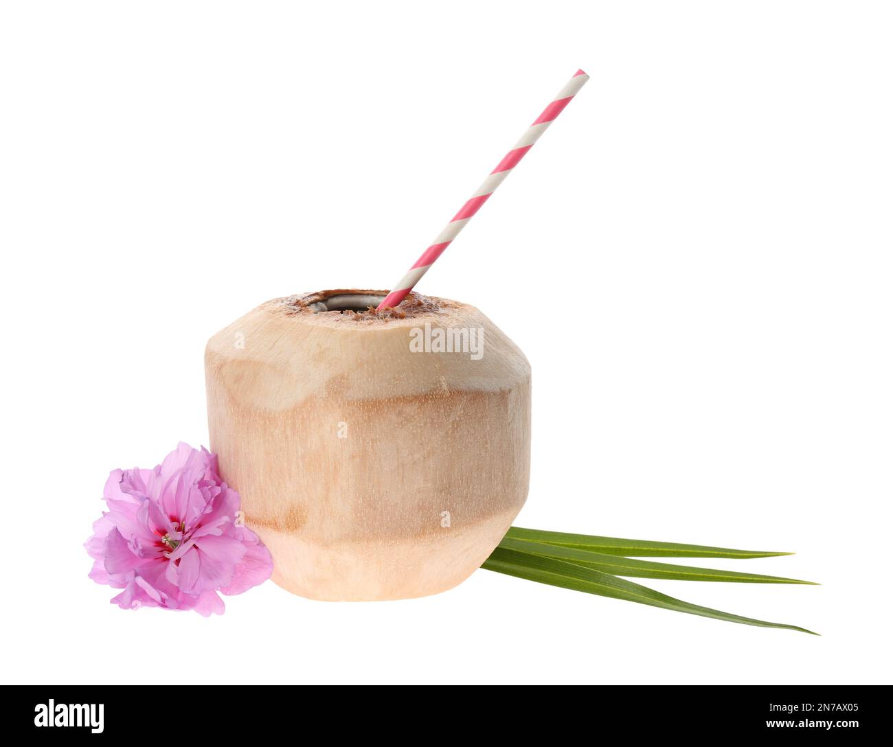 Young peeled coconut with straw, palm leaf and beautiful flower ...