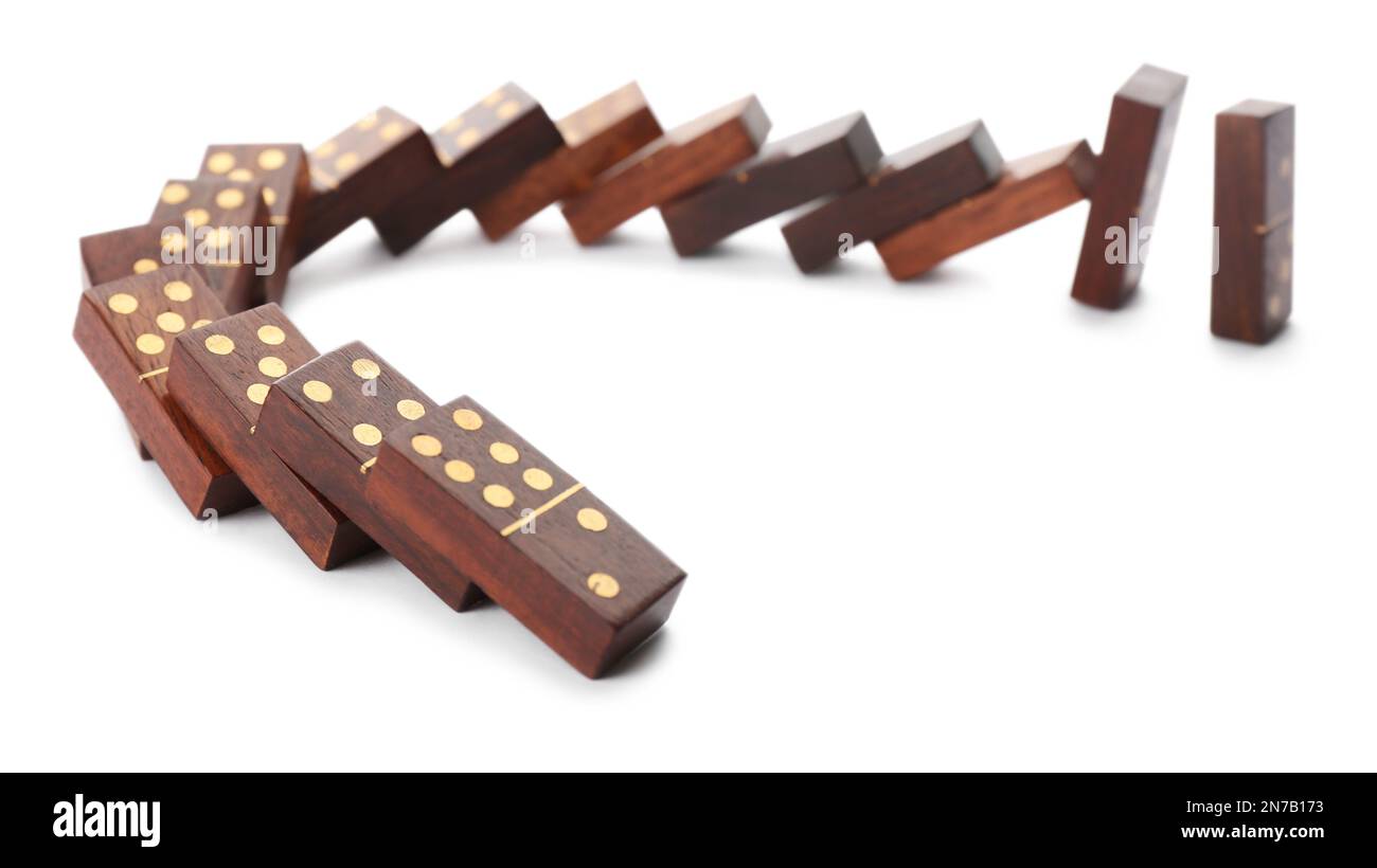 Wooden domino tiles falling on white background Stock Photo - Alamy