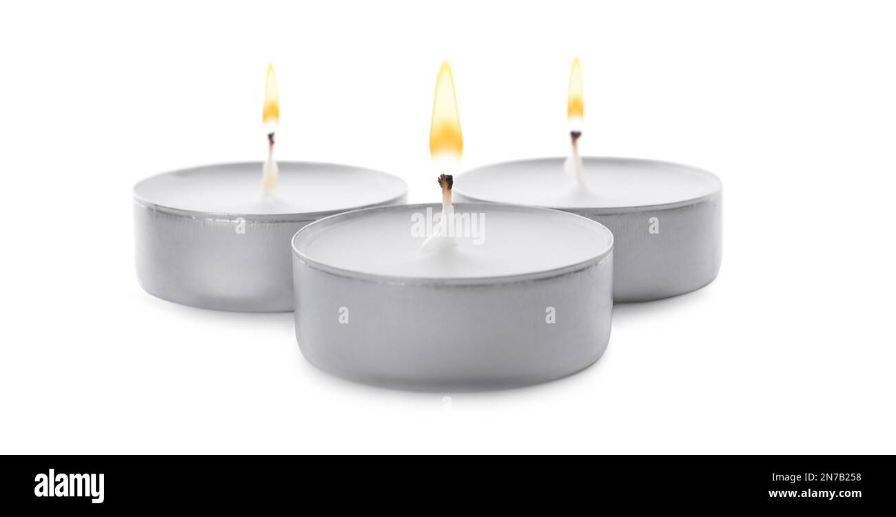 Three small wax candles isolated on white Stock Photo - Alamy