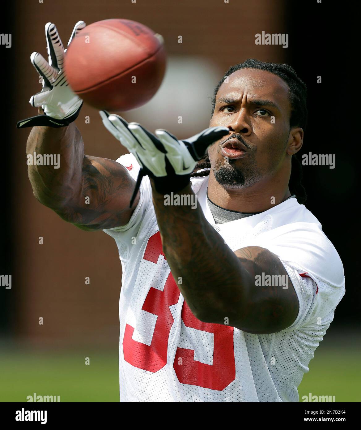 Atlanta Falcons running back Steven Jackson gets loose before an NFL football practice in ...