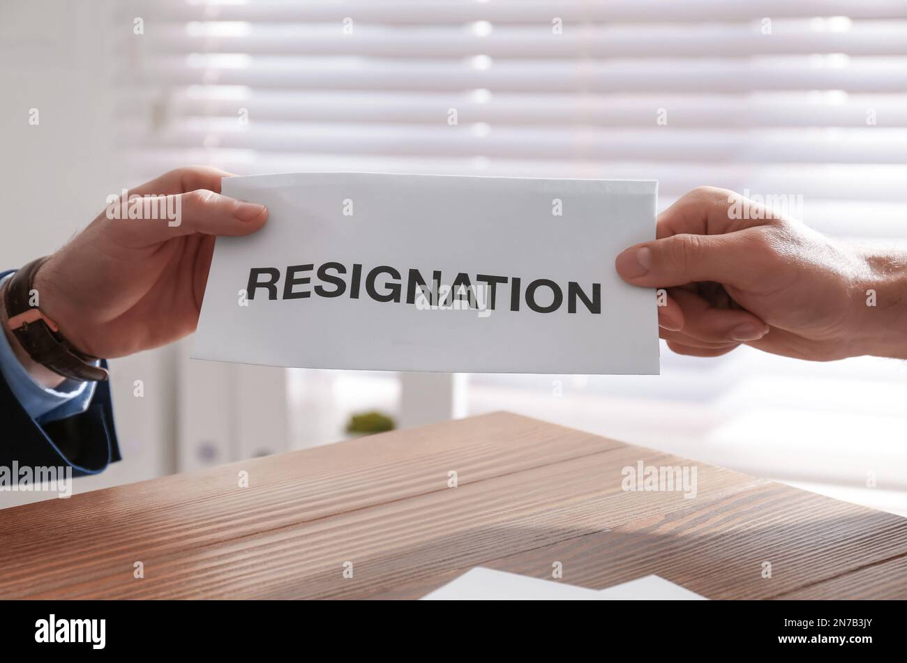 Employee giving resignation letter to boss in office, closeup Stock ...
