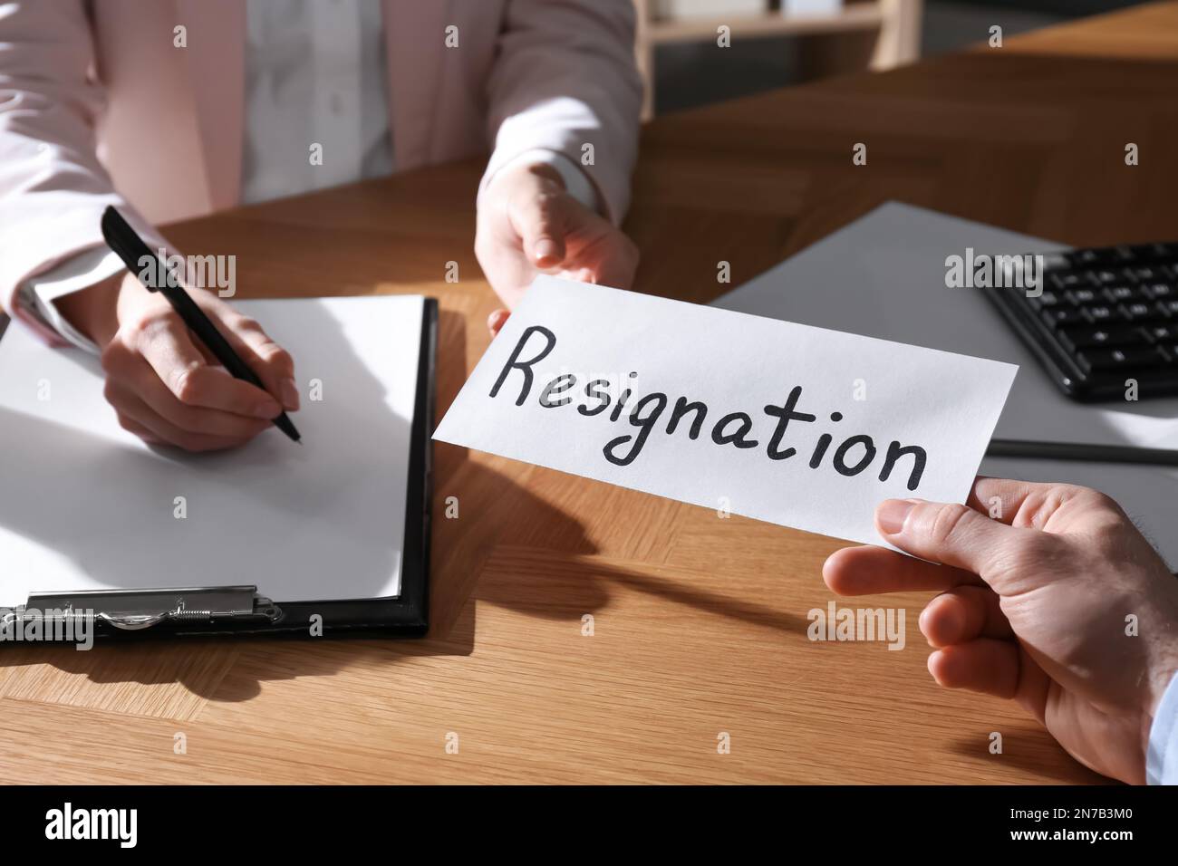 Employee giving resignation letter to boss in office, closeup Stock ...
