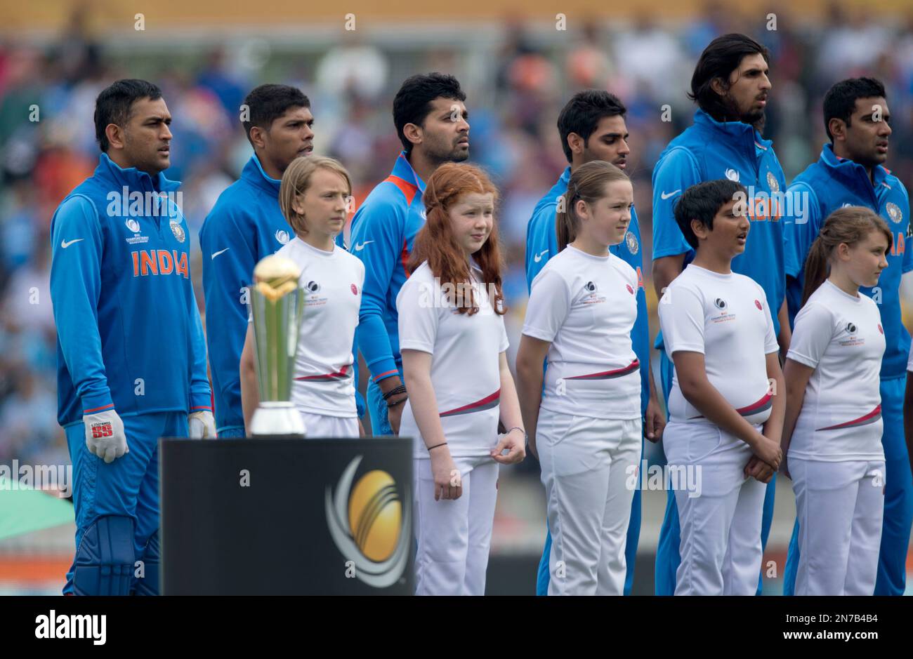 Members of the India team listen to their national anthem as they stand ...