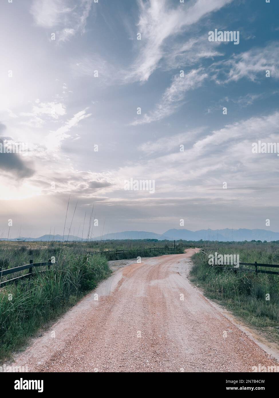 Wide country road among tall grass and wooden fences Stock Photo - Alamy