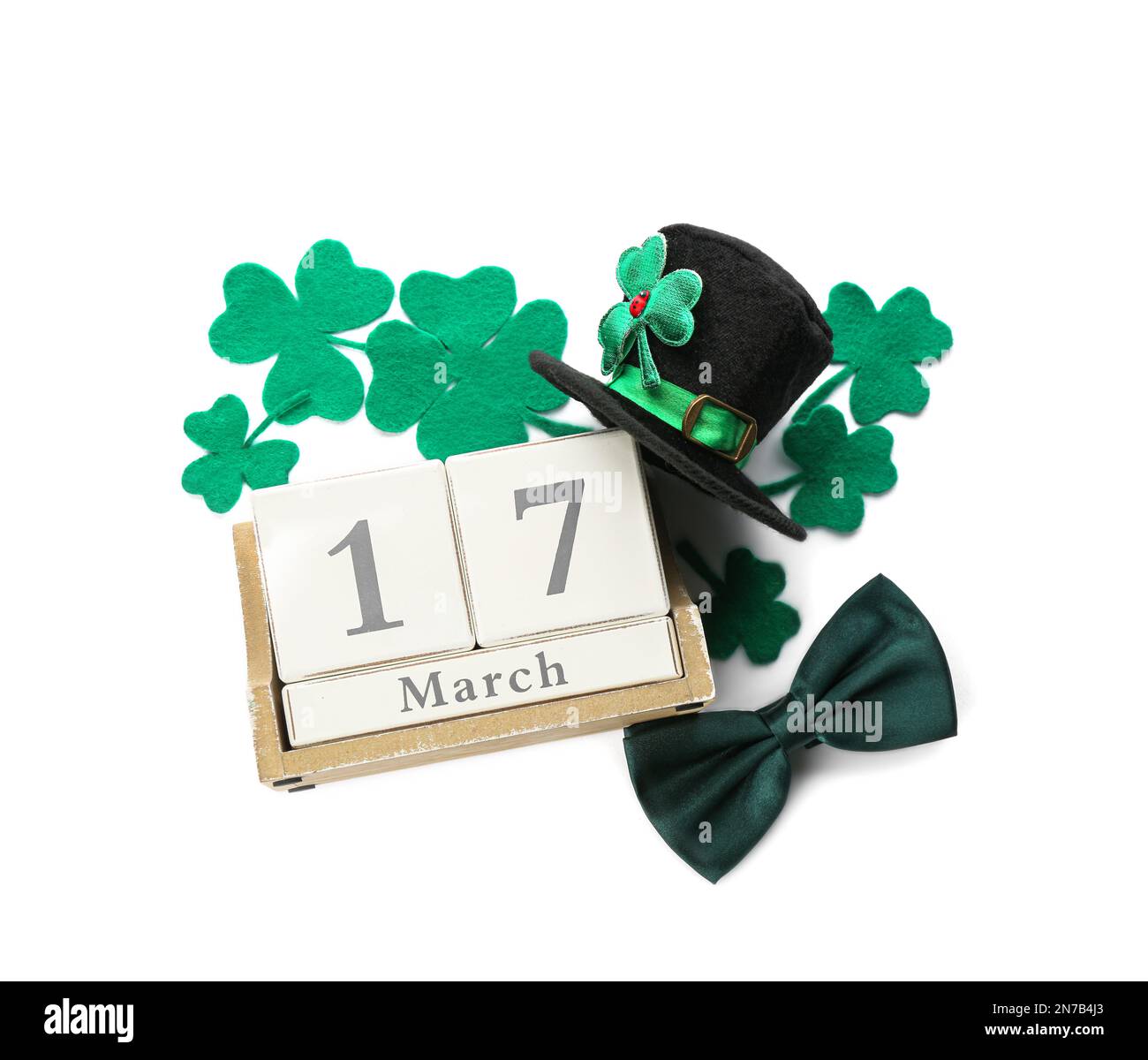 Leprechaun's hat, block calendar and St. Patrick's day decor on white ...