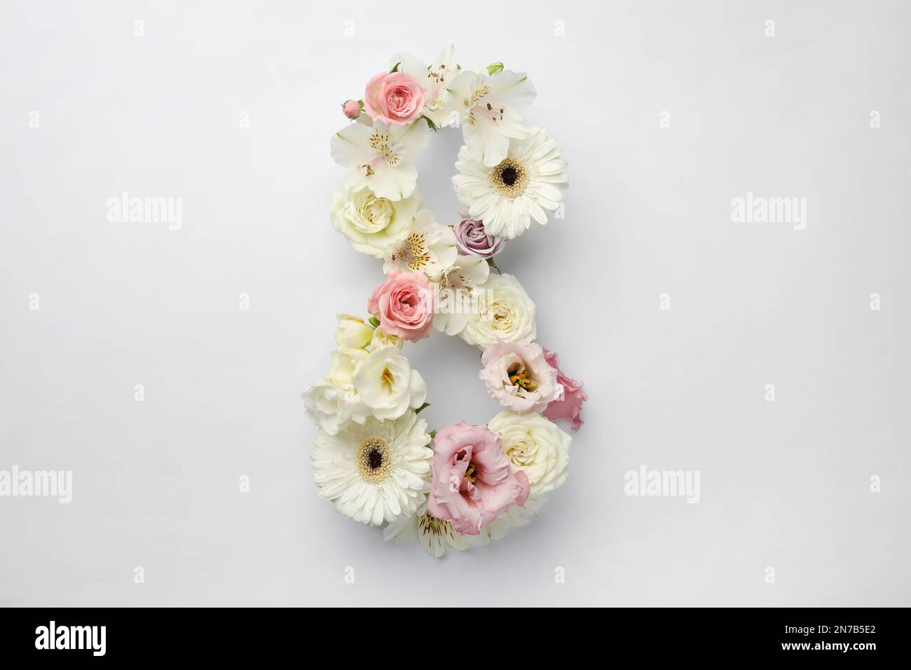 Number 8 made of beautiful flowers on white background, flat lay ...