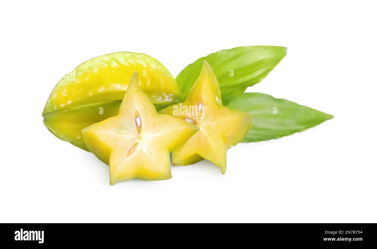 Cut and whole carambolas with green leaves on white background Stock ...