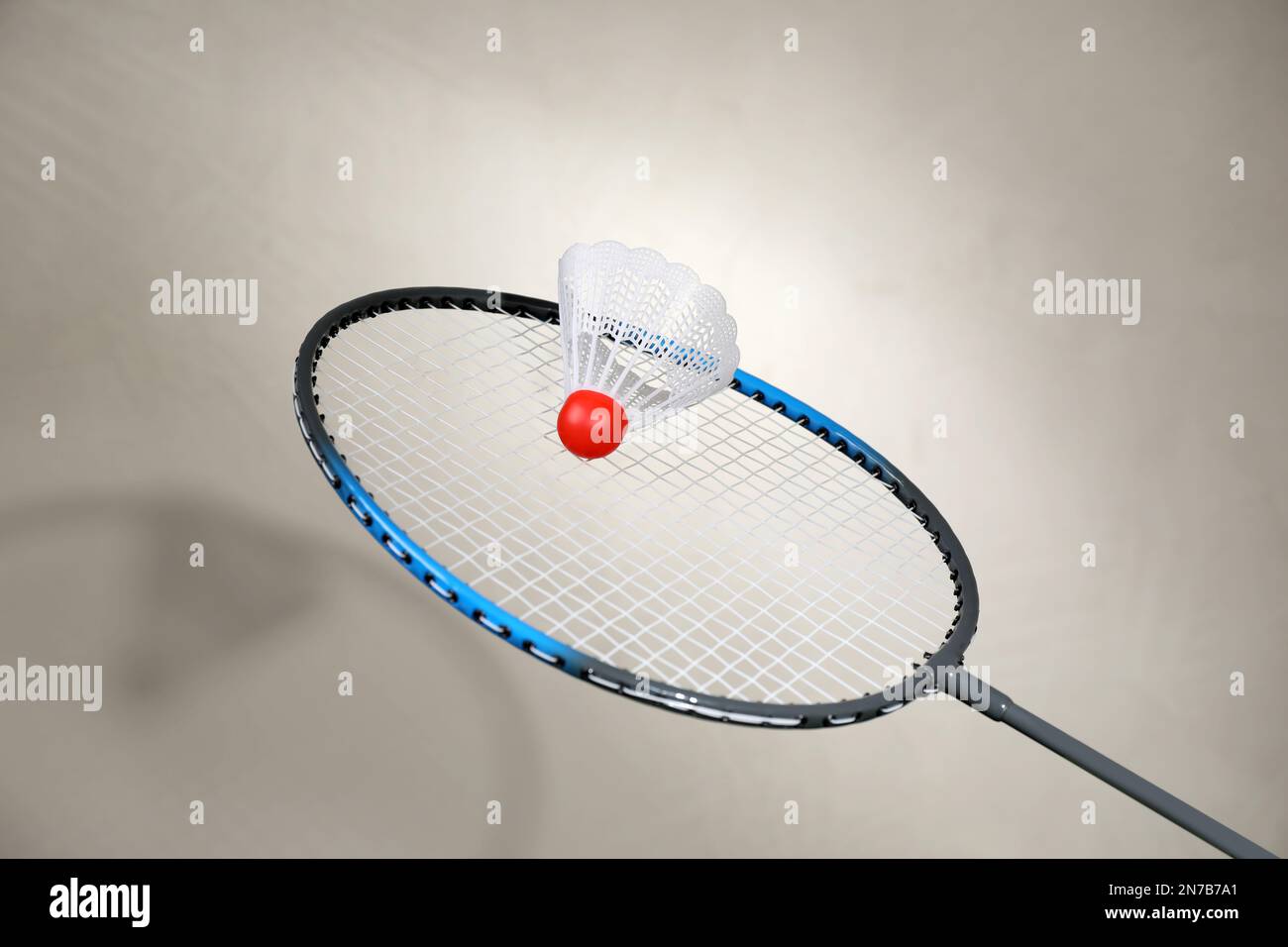 Shuttlecock and racquet on light background. Badminton equipment Stock ...