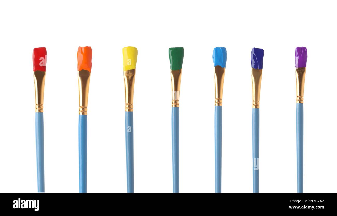 Collage of brushes with different bright paints on white background ...