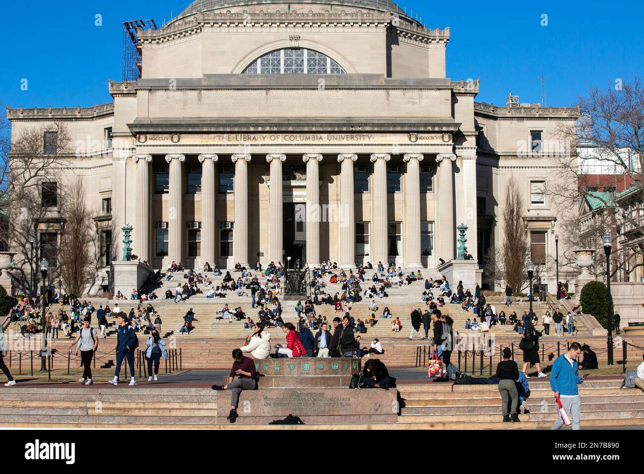 On an unseasonably warm day, students relax on the front steps of Low ...