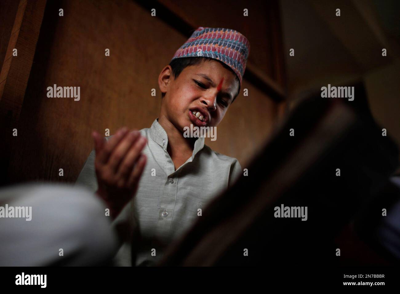 A young student studies Sanskrit scripts while studying at ...