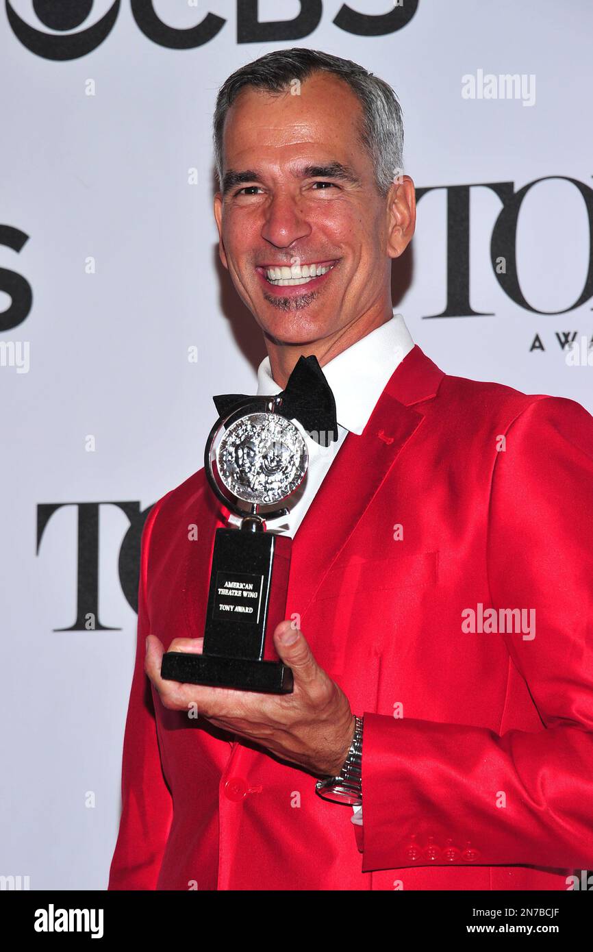 Jerry Mitchell poses with his award in the press room at the 67th ...