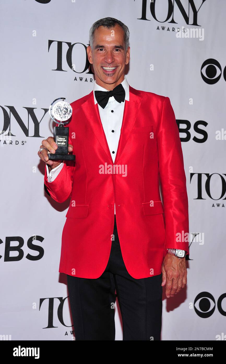 Jerry Mitchell poses with his award in the press room at the 67th ...