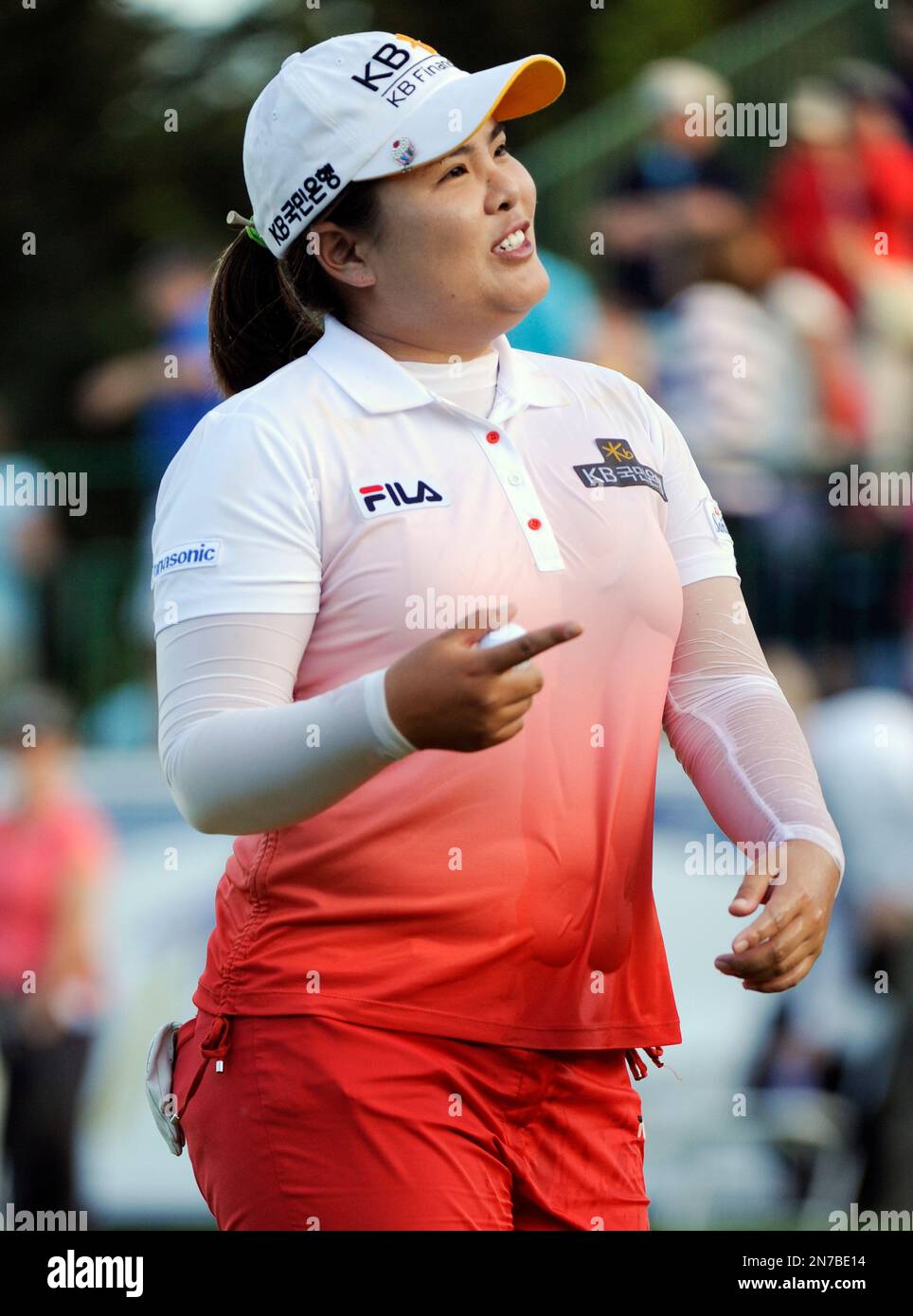 Inbee Park looks up at the stands as she holds the ball after winning a ...