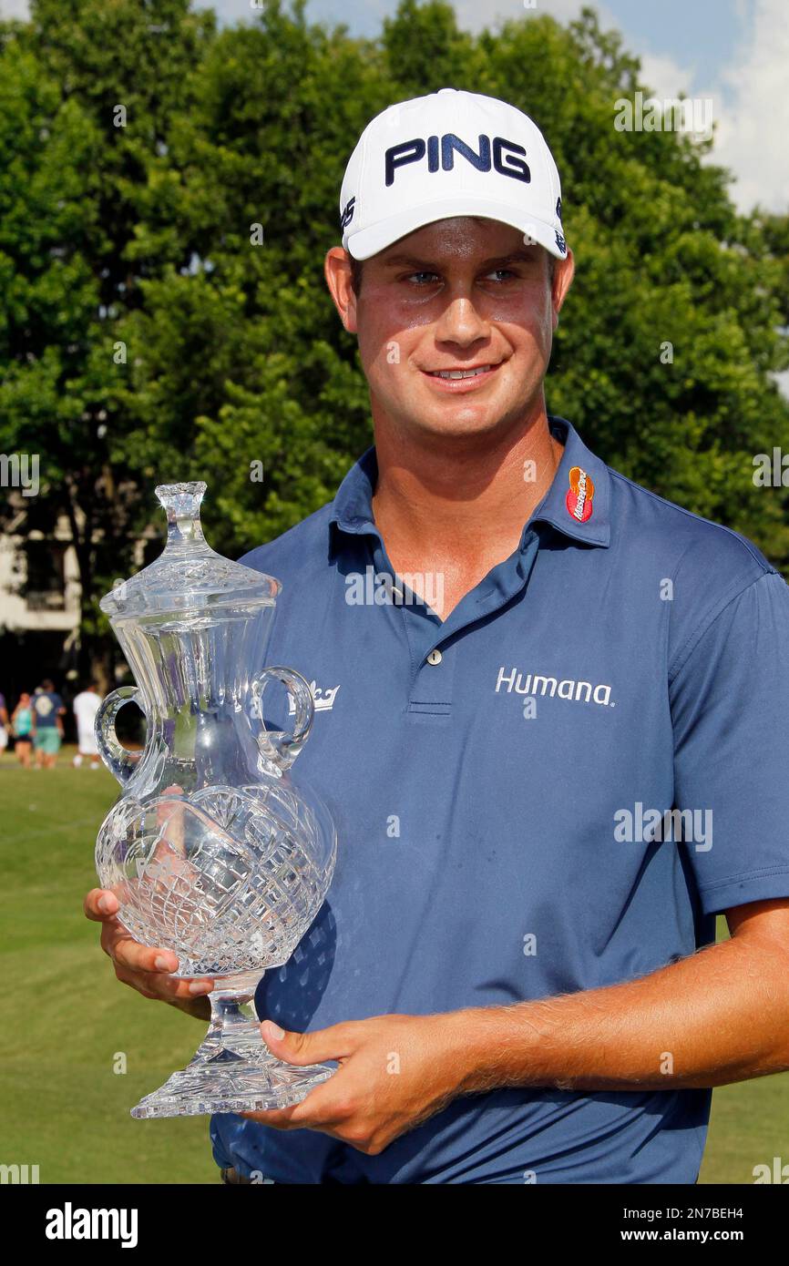 Harris English holds the trophy after winning the St. Jude Classic golf ...
