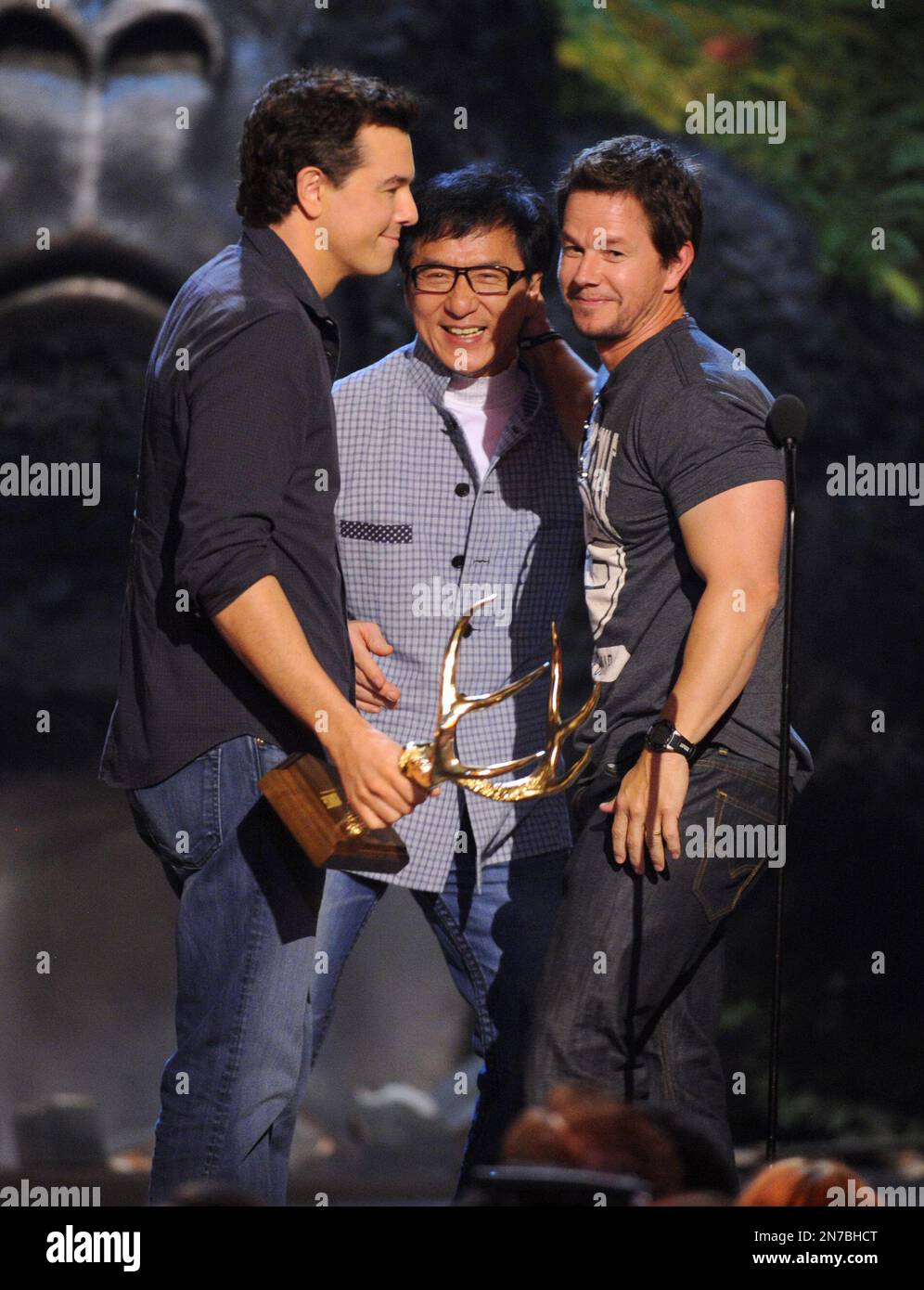 Jackie Chan, center, presents the award for guy movie of the year to Seth MacFarlane, left, and ...
