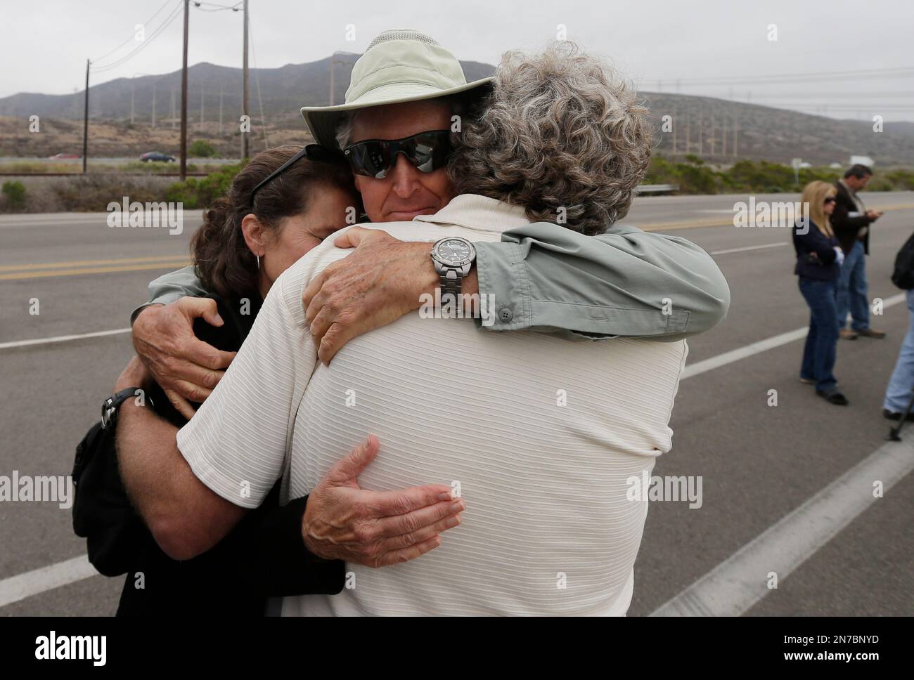 Gary Headrick, right, hugs Steve Netherby, center, and his wife Laurie ...