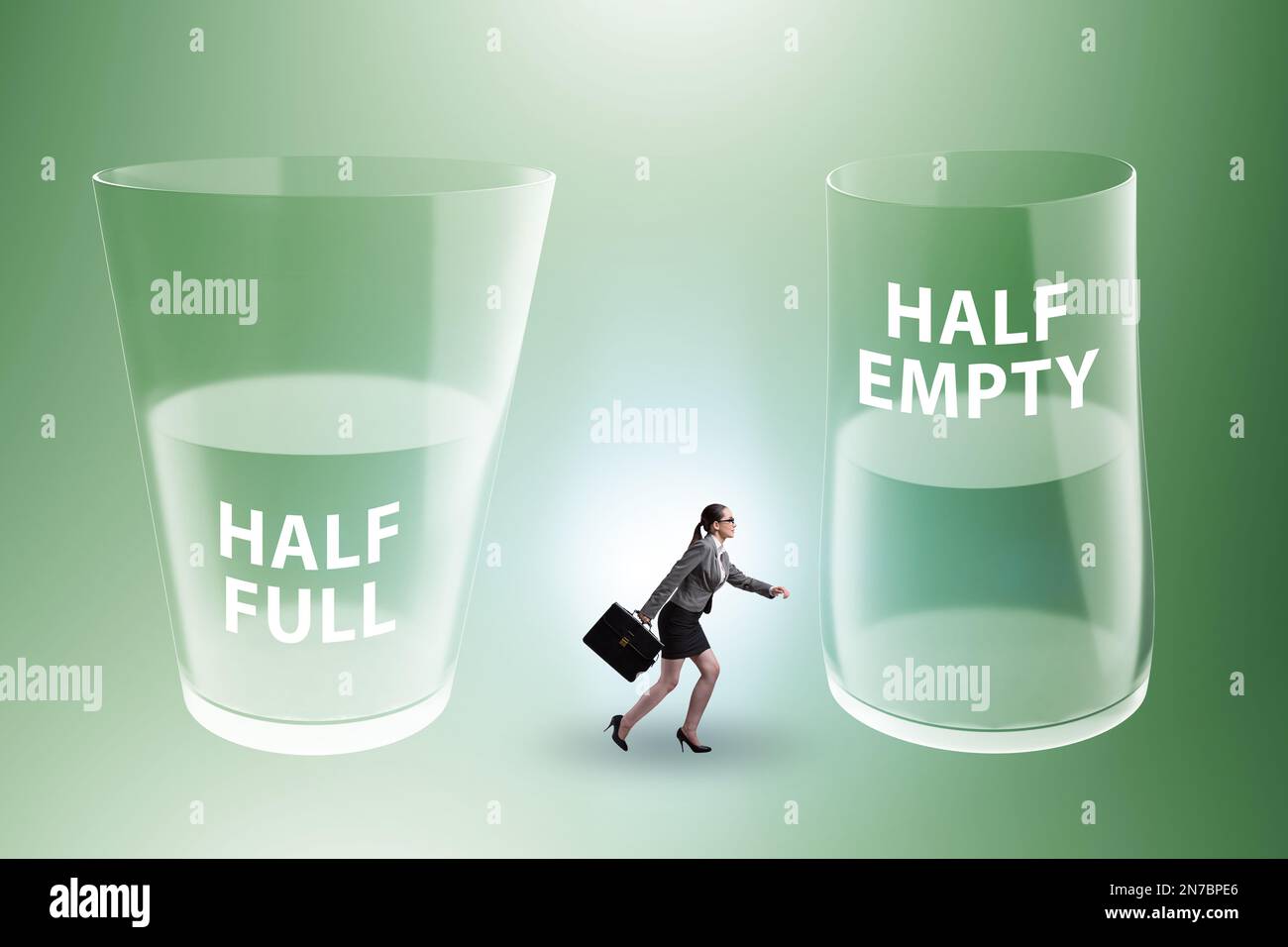 Businesswoman in the half empty half full glass concept Stock Photo - Alamy