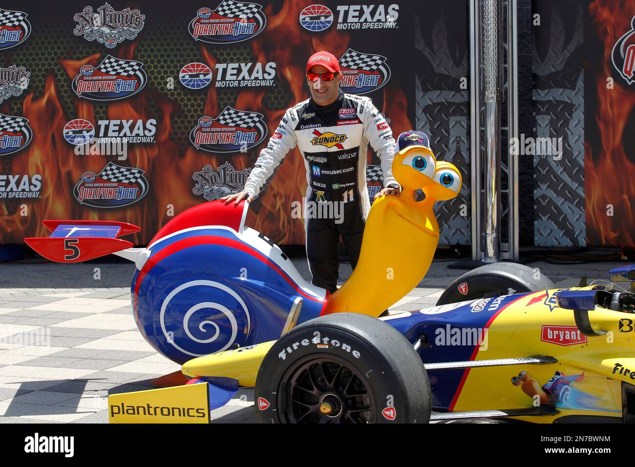 Tony Kanaan of Brazil poses for photos showing off the new Sunoco ...