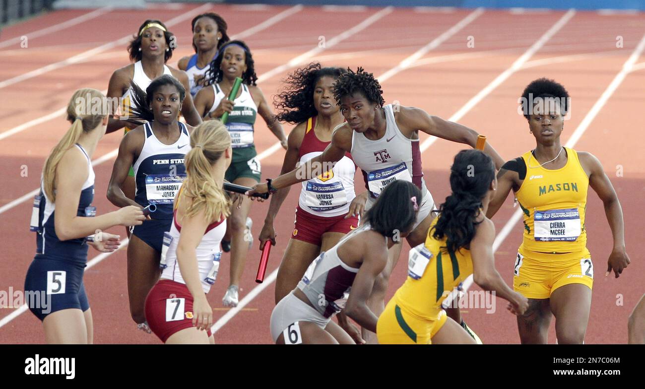 The baton handoff point becomes crowded in a preliminary of the women's ...