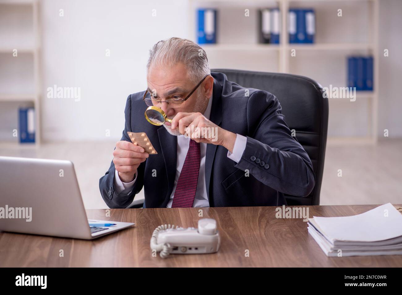 Old male employee feeling bad at workplace Stock Photo - Alamy