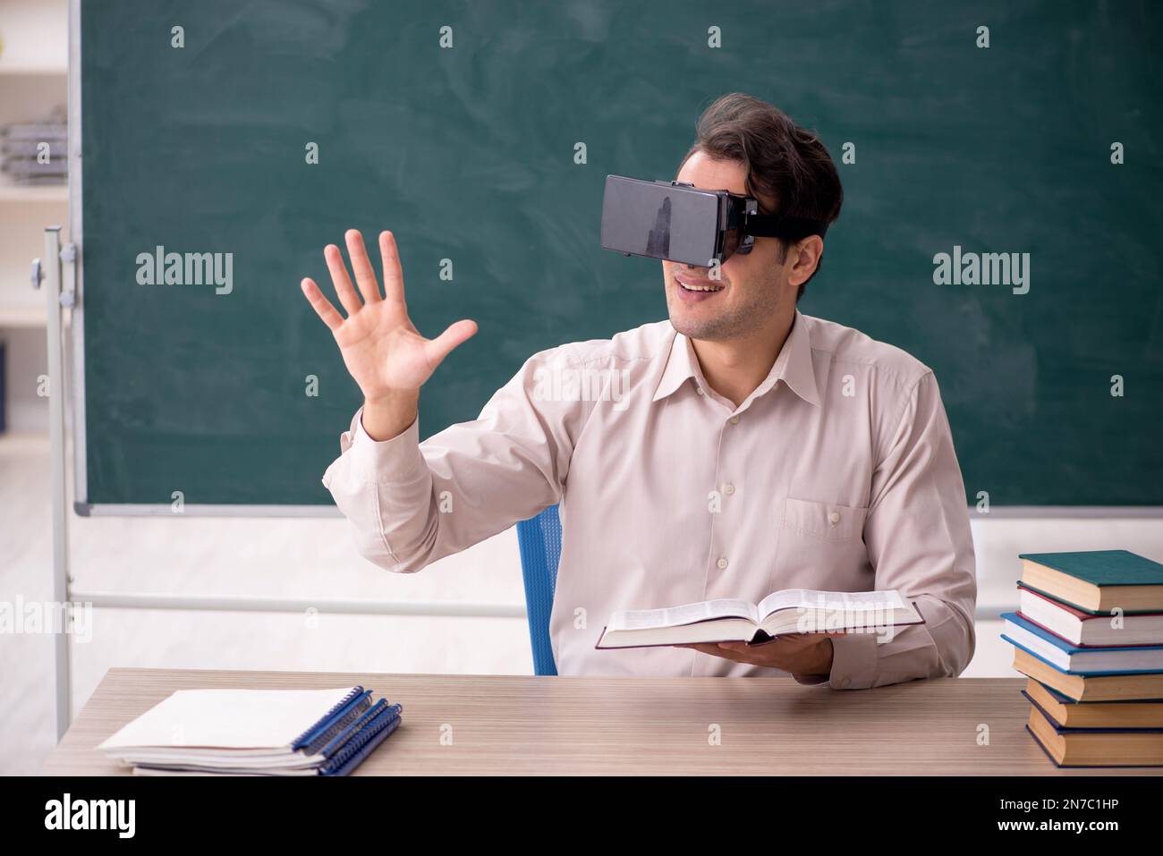 Young student wearing virtual glasses in the classroom Stock Photo - Alamy
