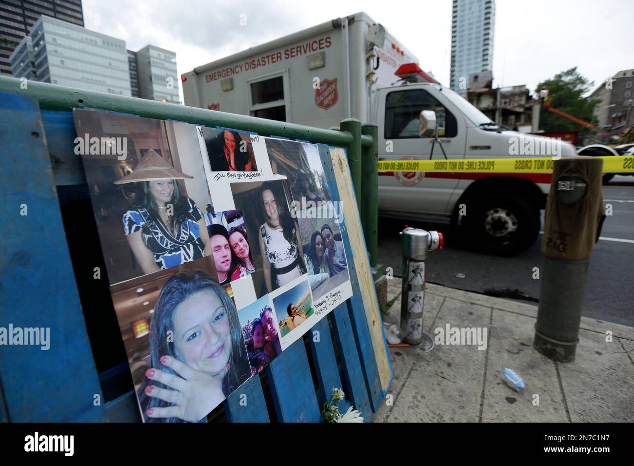 A reporter makes a photograph of a makeshift memorial for Kimberly J ...