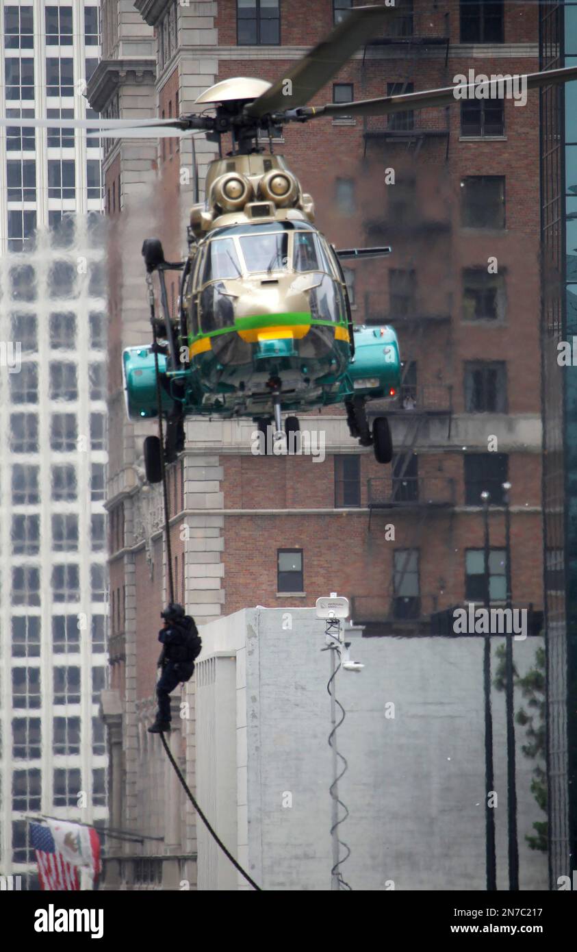A Los Angeles police officer repels from a helicopter while taking part ...