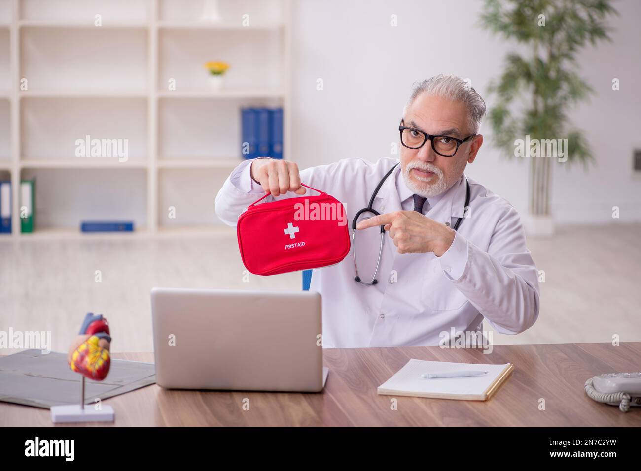 Old doctor paramedic holding first aid bag Stock Photo - Alamy