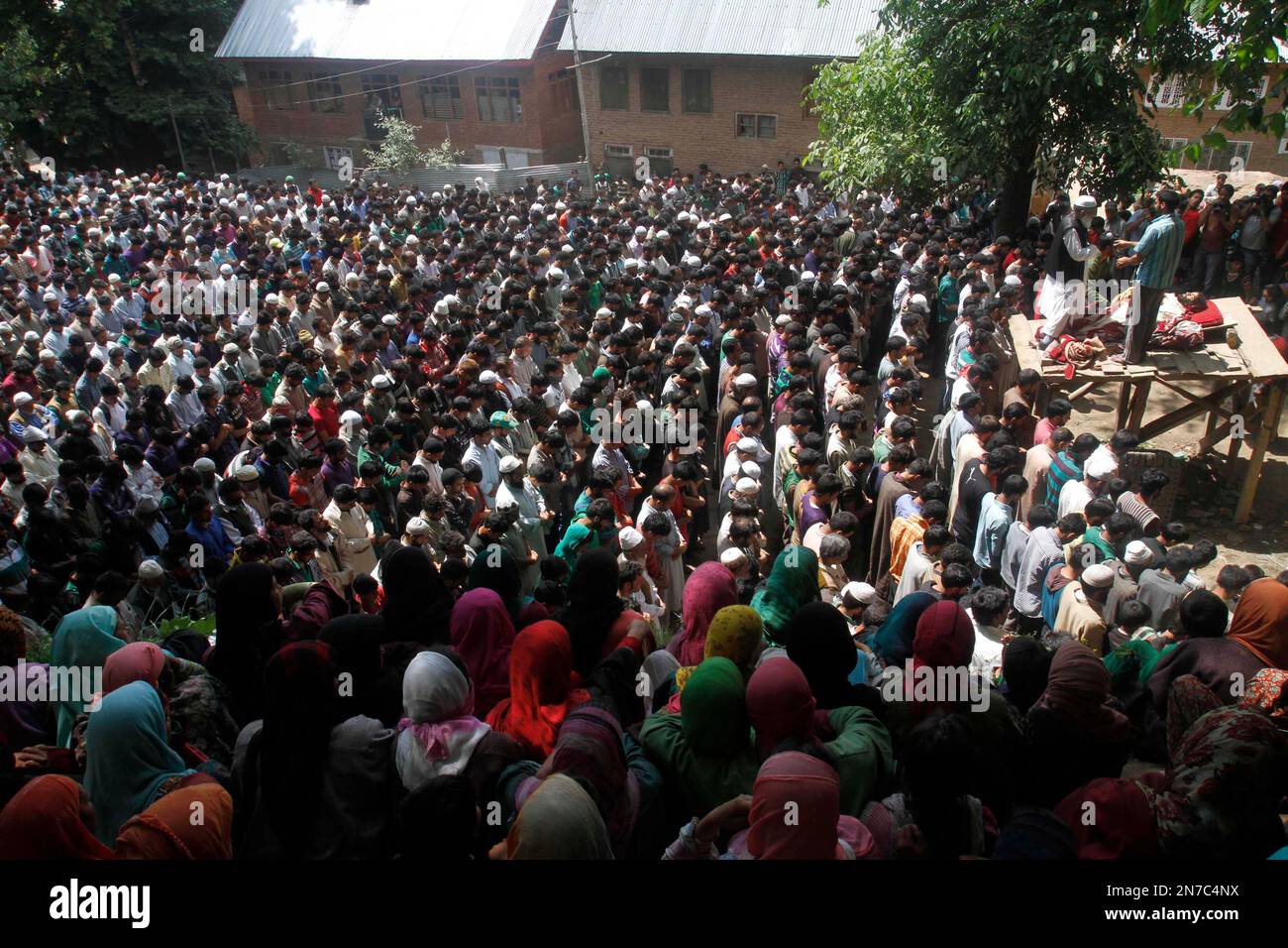 Kashmiri villagers offer prayers during the funeral of Altaf Baba alias ...