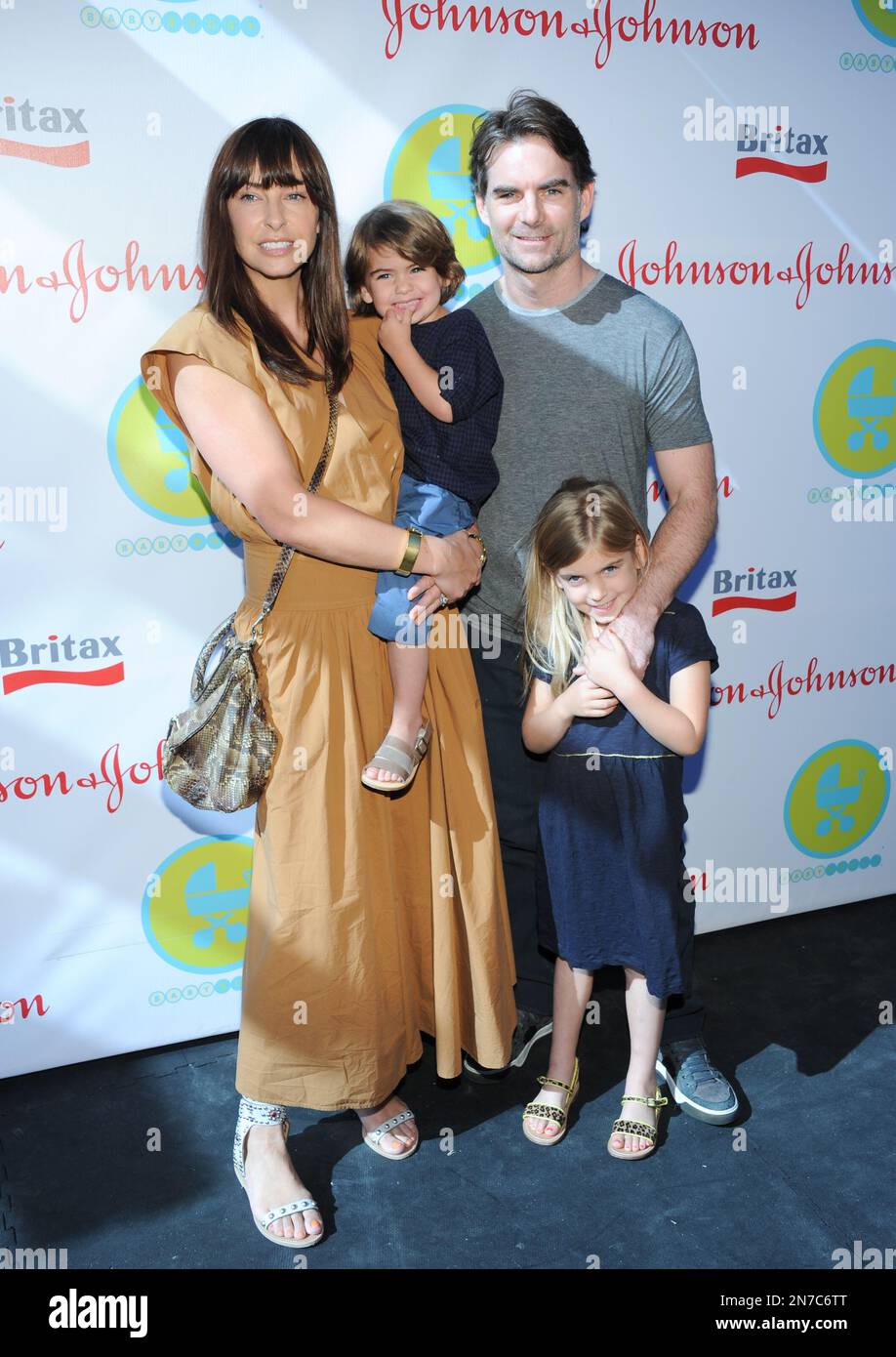 Professional stock car racing driver Jeff Gordon poses with his wife ...