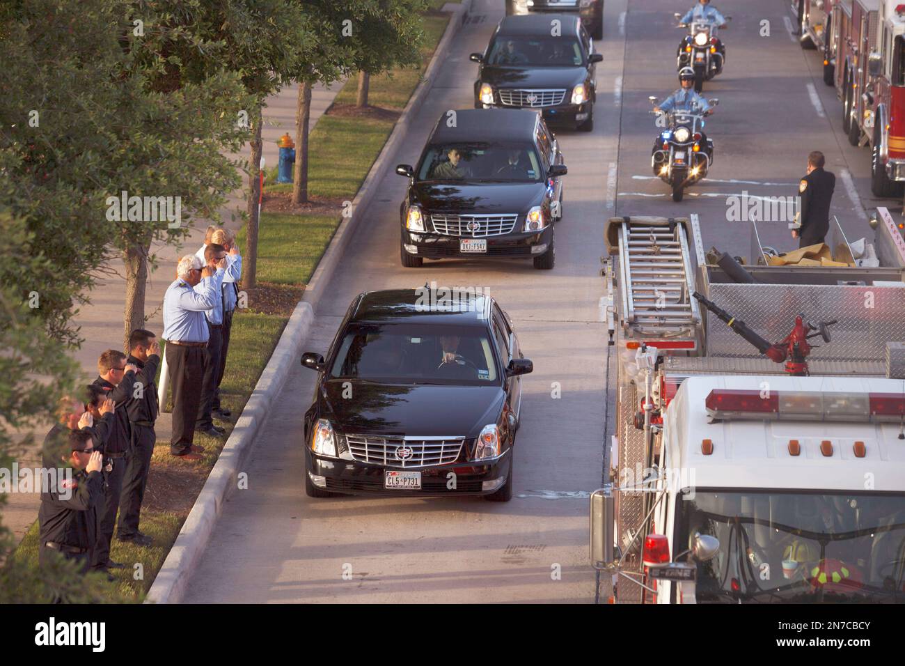 Firefighter's salute arriving families before a memorial procession ...