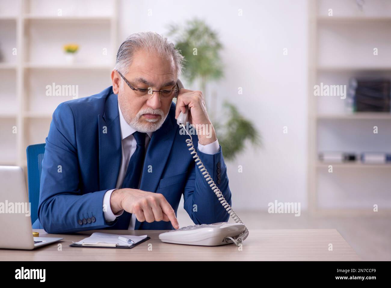 Old boss working in the office Stock Photo - Alamy