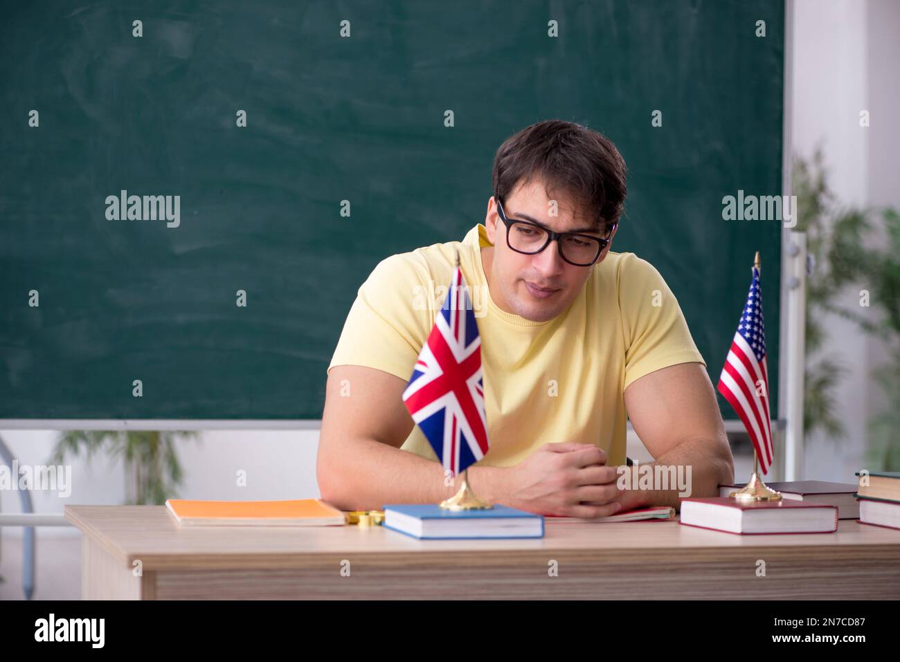 Young English language teacher sitting in the classroom Stock Photo - Alamy